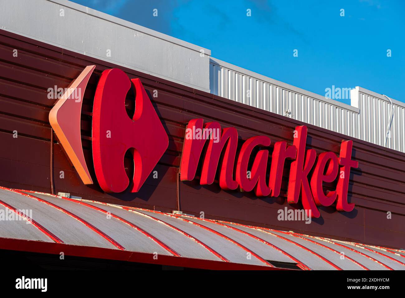 Sign and logo of a Carrefour Market supermarket. Carrefour is a French ...