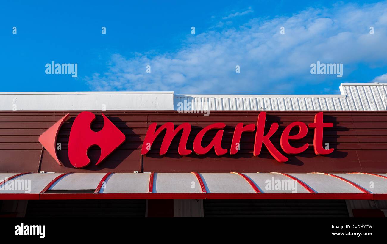 Sign and logo of a Carrefour Market supermarket. Carrefour is a French ...