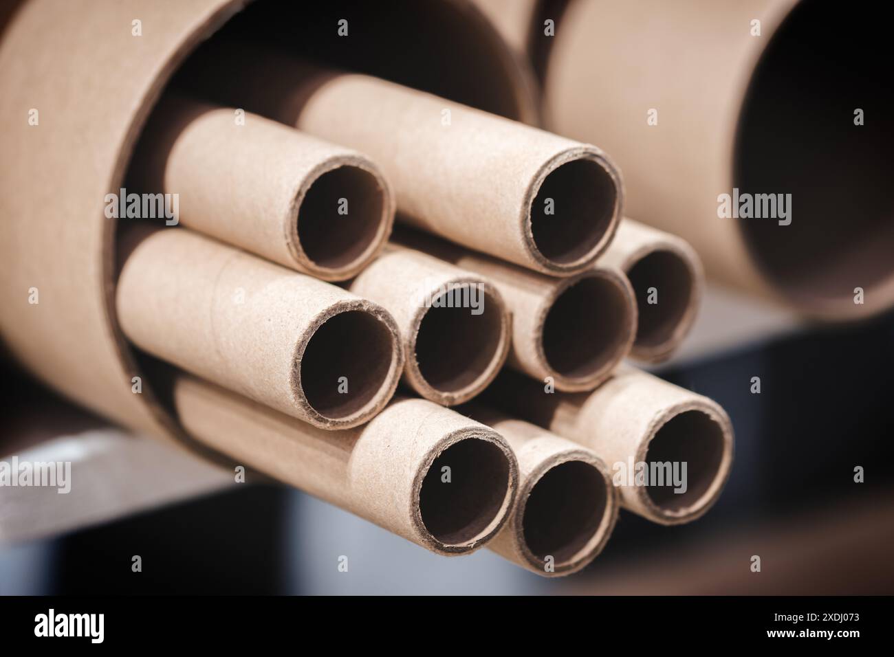 A stack of cardboard tubes as background. The tubes are brown and are ...