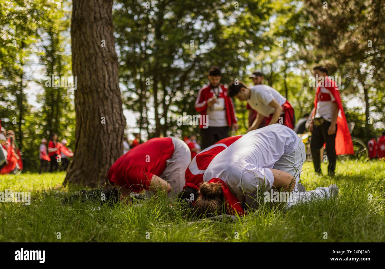 Dortmund, Germany. 22nd Jun 2024. Turkish fans pray before the match ...