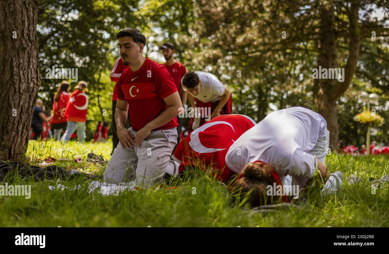 Dortmund, Germany. 22nd Jun 2024. Turkish fans pray before the match ...