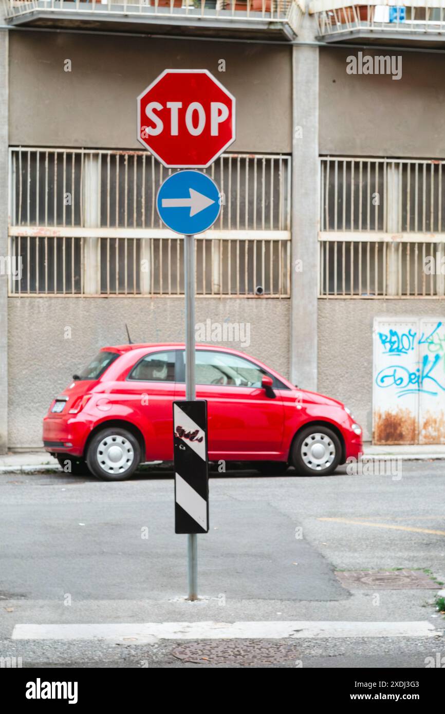 Cremona, Italy - June 21st 2024 Red car parked on side of street with ...