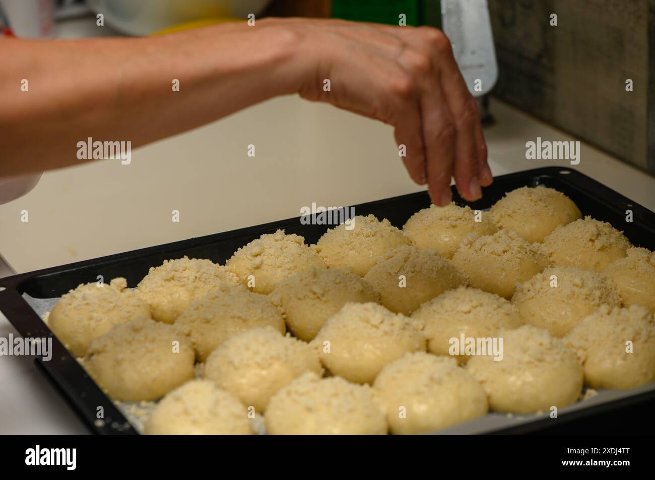 woman sprinkles buns in the kitchen 9 Stock Photo - Alamy