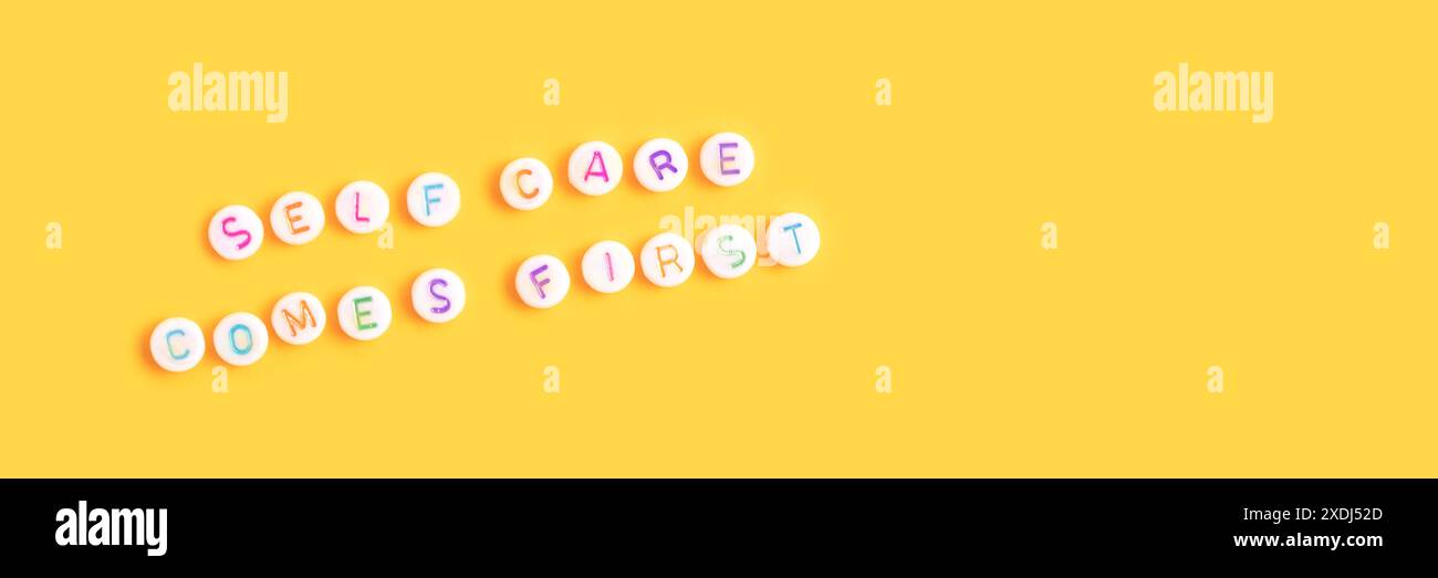 Self care comes first. Banner with quote made of beads with letters on ...