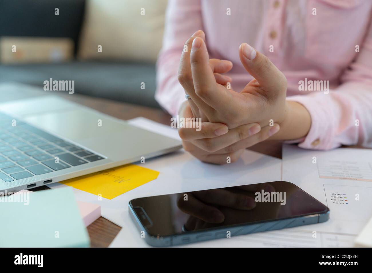 Wrist pain from excessive computer typing Stock Photo - Alamy