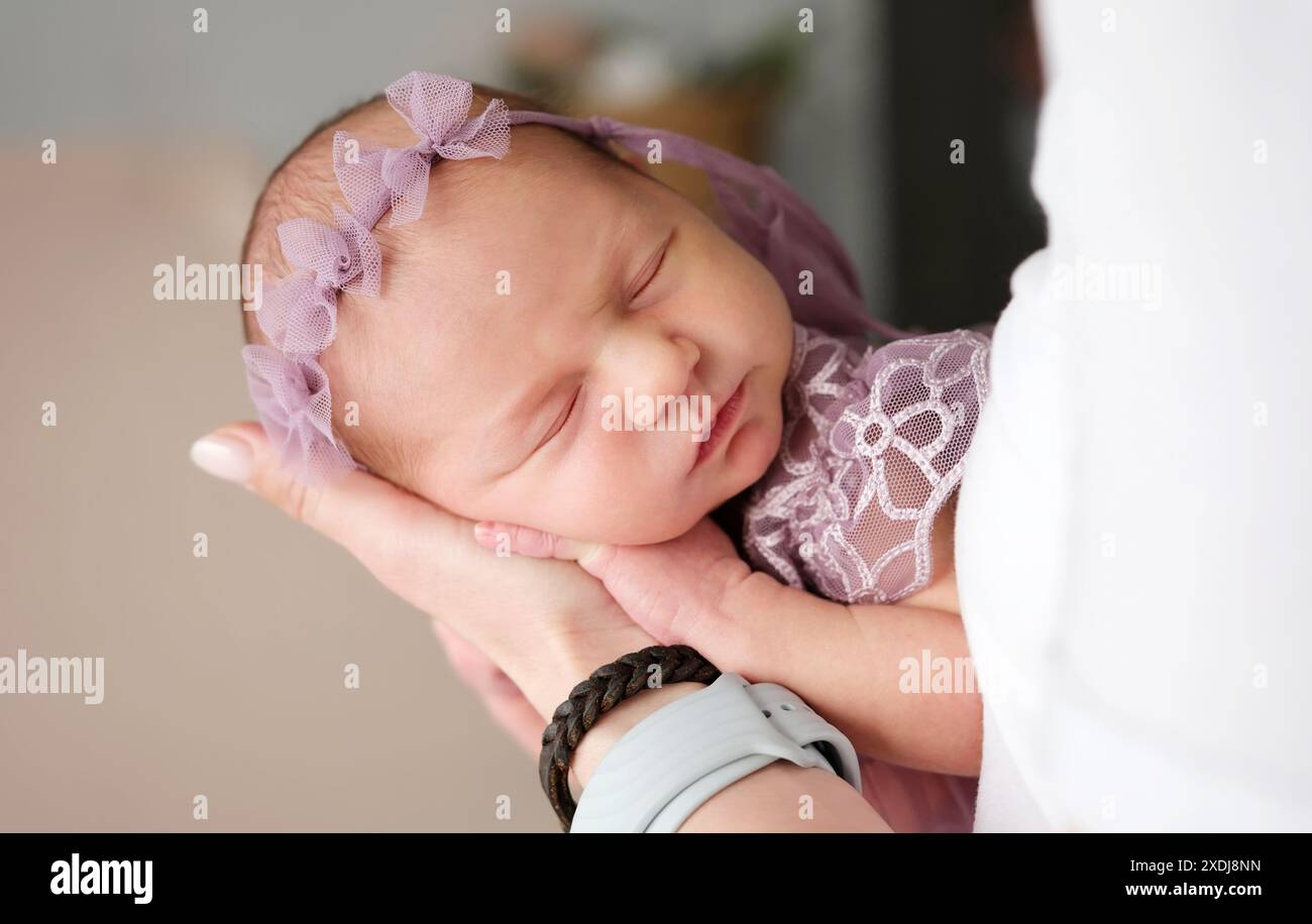 Mother Cradling Adorable Newborn Baby Girl In Wreath In Her Arms Stock ...
