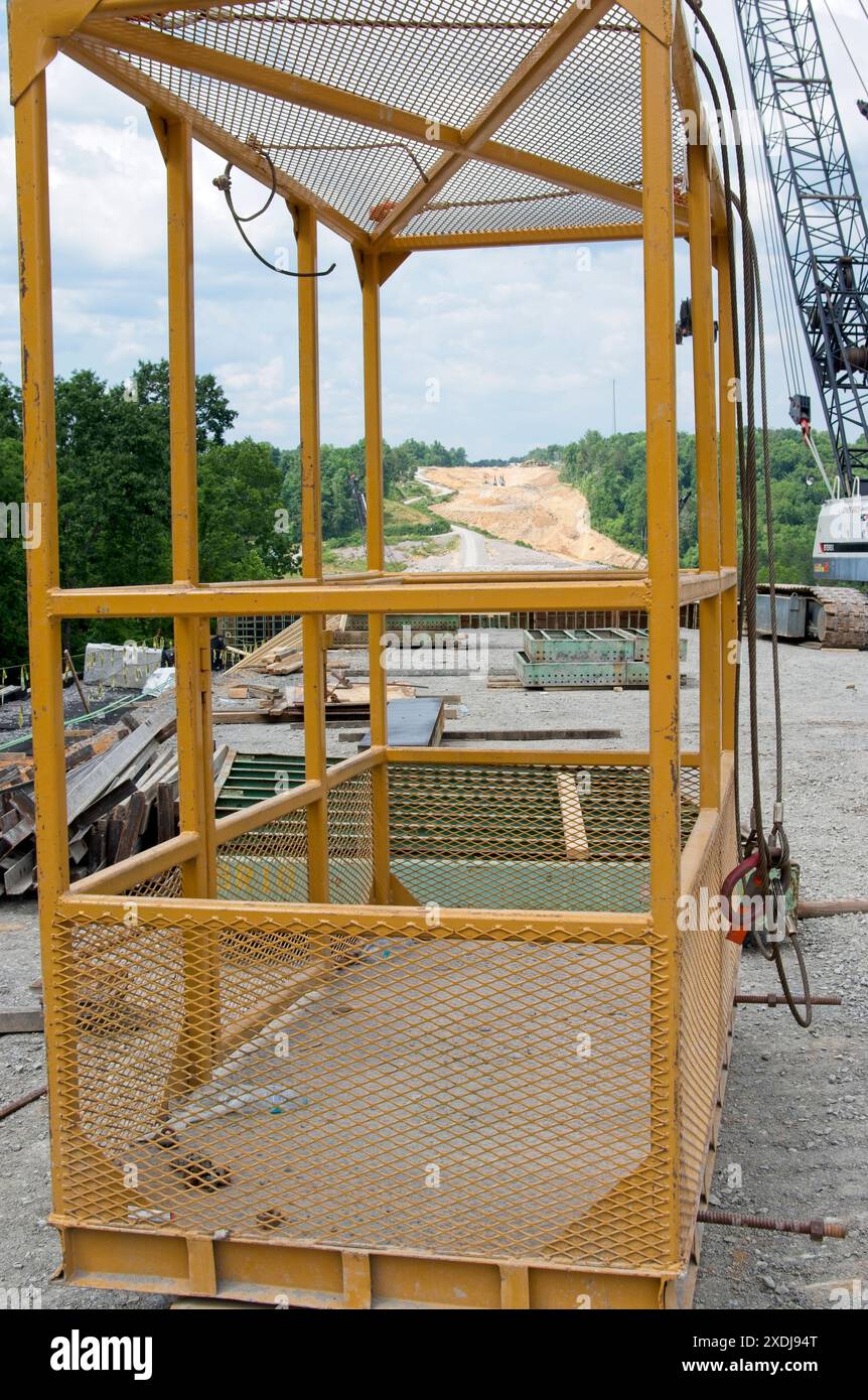 Cage used to life workers with a crane Stock Photo - Alamy