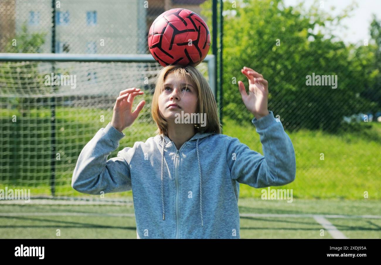 Small Girl Soccer Player Practicing With Ball On A Soccer Field Stock ...