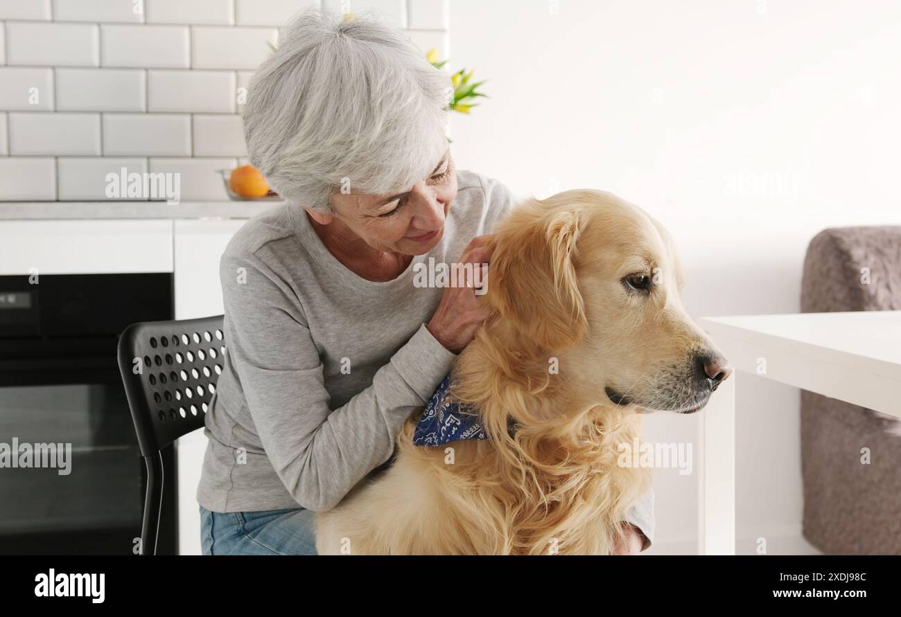 Cheerful Old Lady Petting Her Cute Golden Retriever Dog With A Smile ...