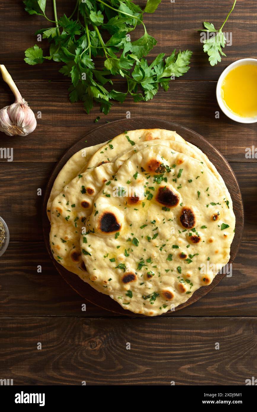 Homemade indian naan bread with garlic butter on wooden background. Top ...