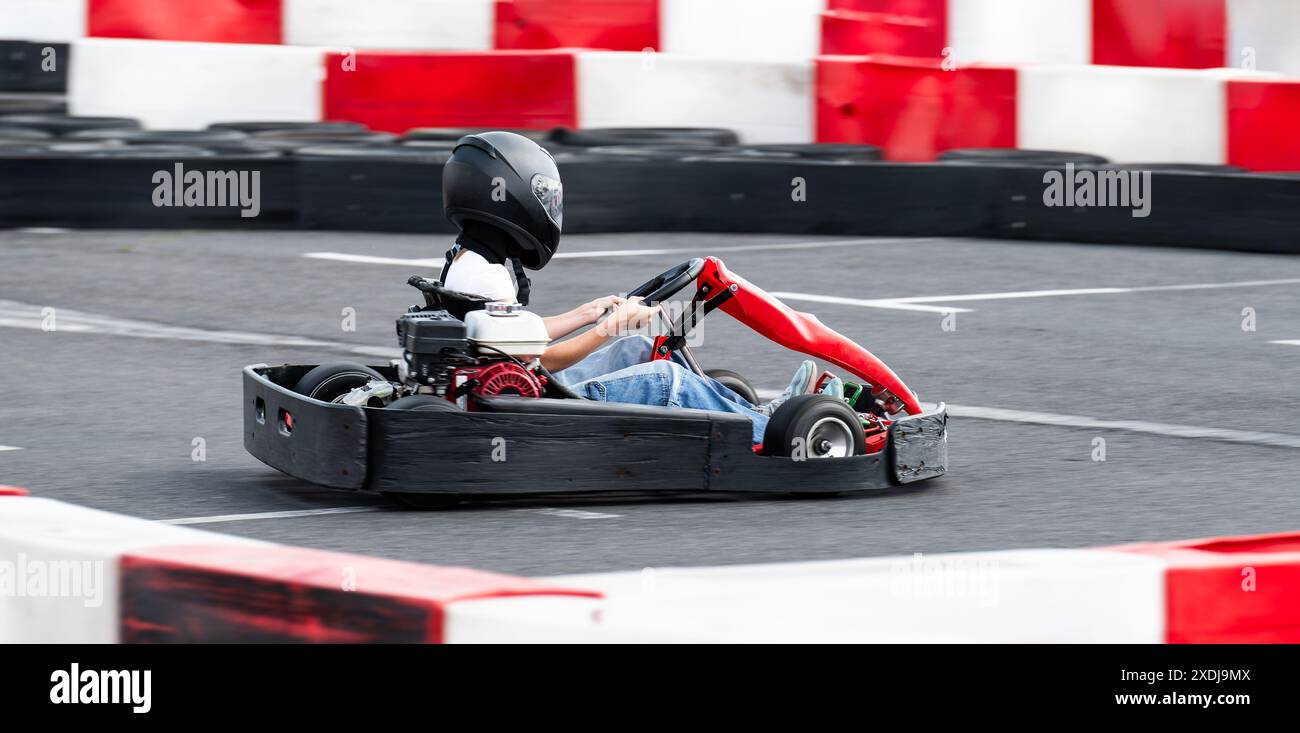 Kid Driving Fast Go Kart By Racing Track, Extreme Entertainment Stock ...