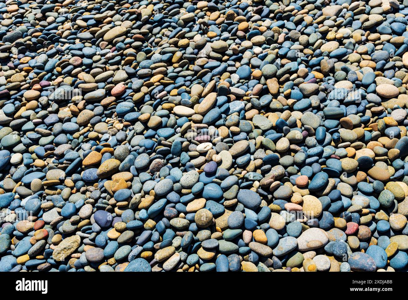 Colorful worn stones along beach; South Carlsbad State Beach Park ...