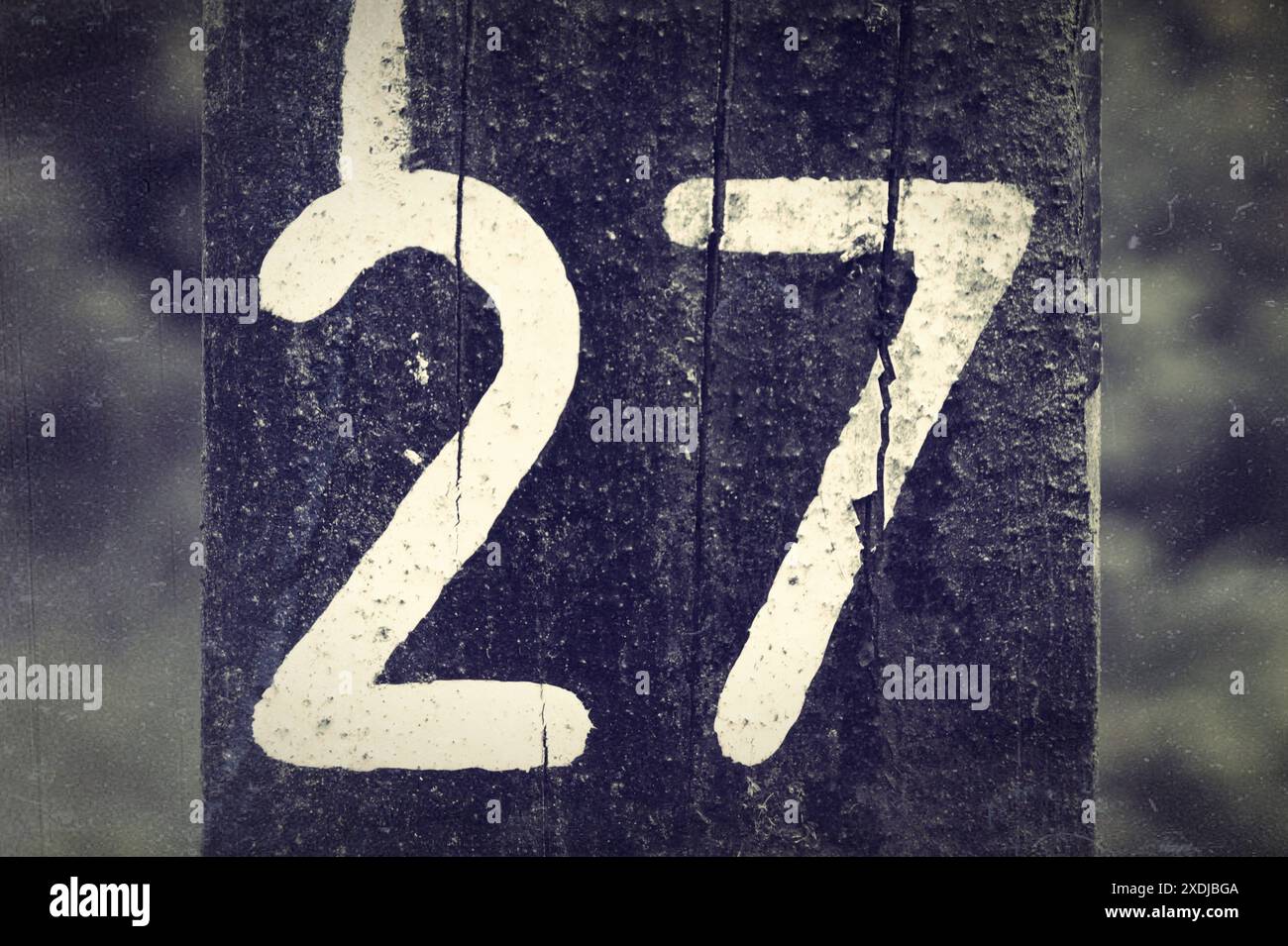 Number 27, White number on a dark background. Black and white old photo ...