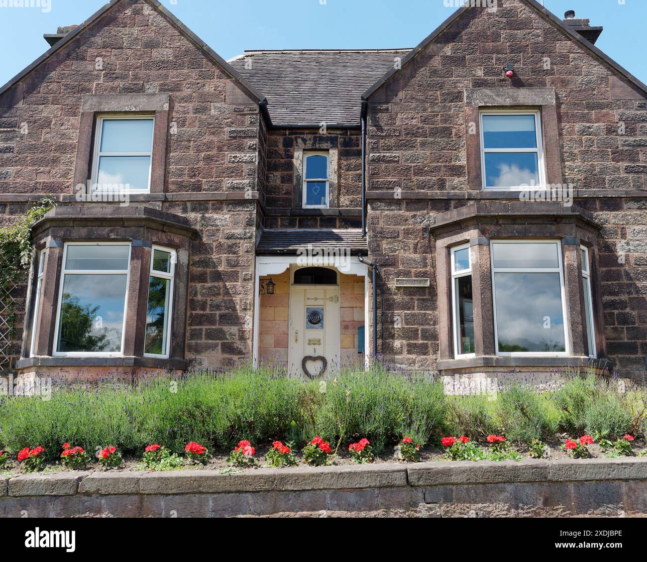 Quaint historic stone built terraced house with heart shape on door in ...