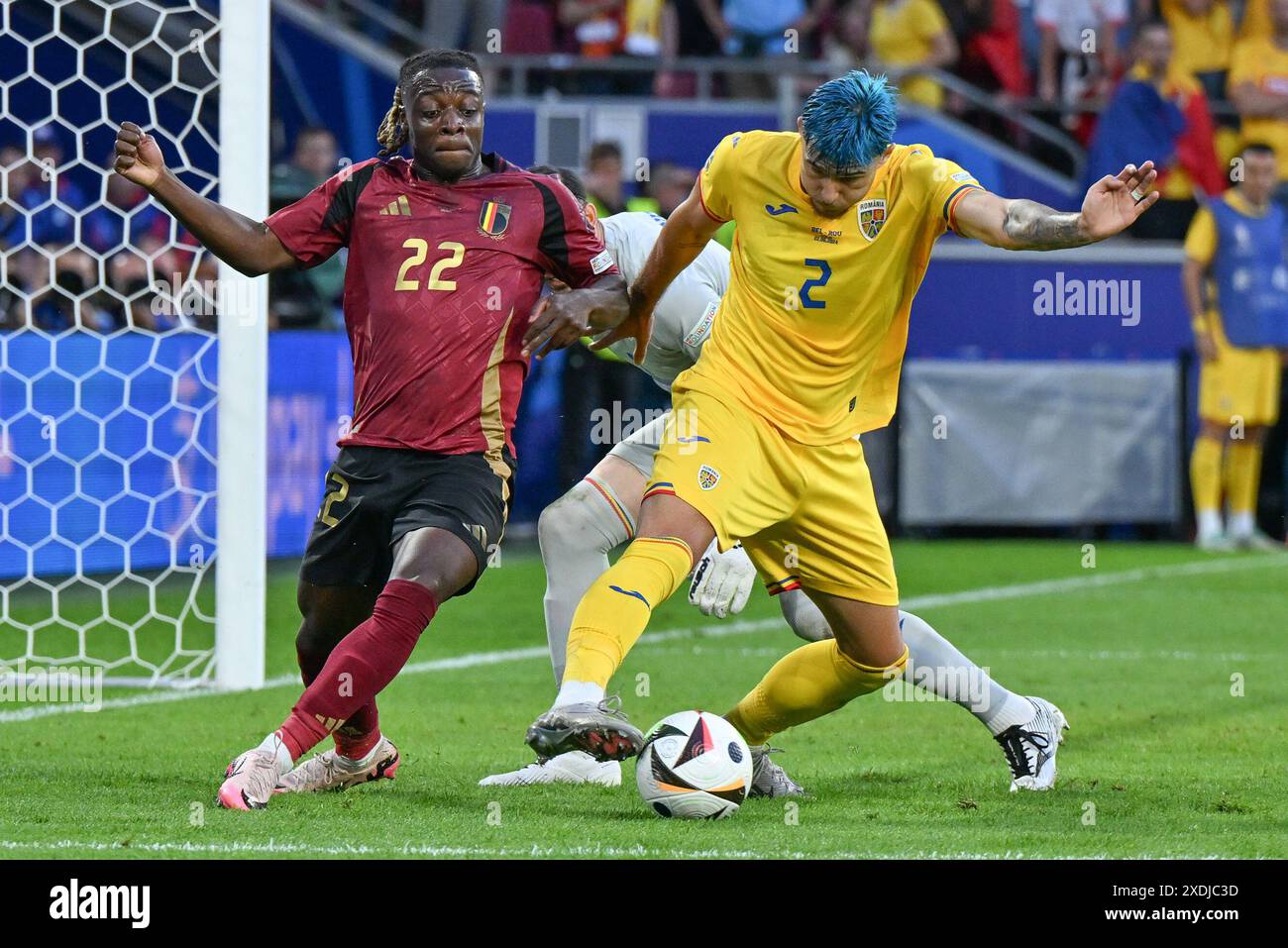 Jeremy Doku (22) of Belgium fighting for the ball with Andrei Ratiu (2 ...
