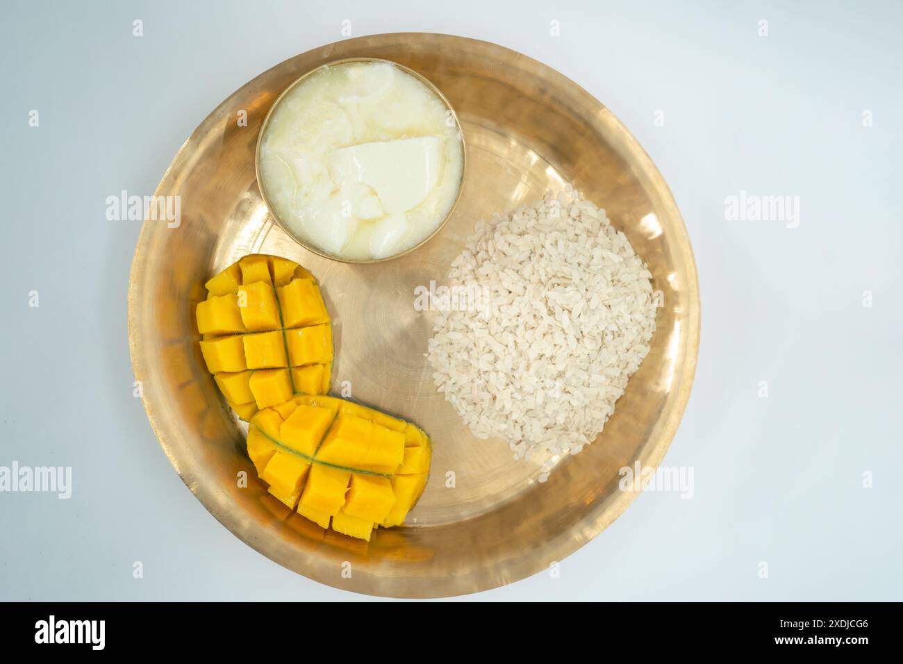 A copper plate and bowl of Dahi Chiura aka Yoghurt and Rice Flakes for ...