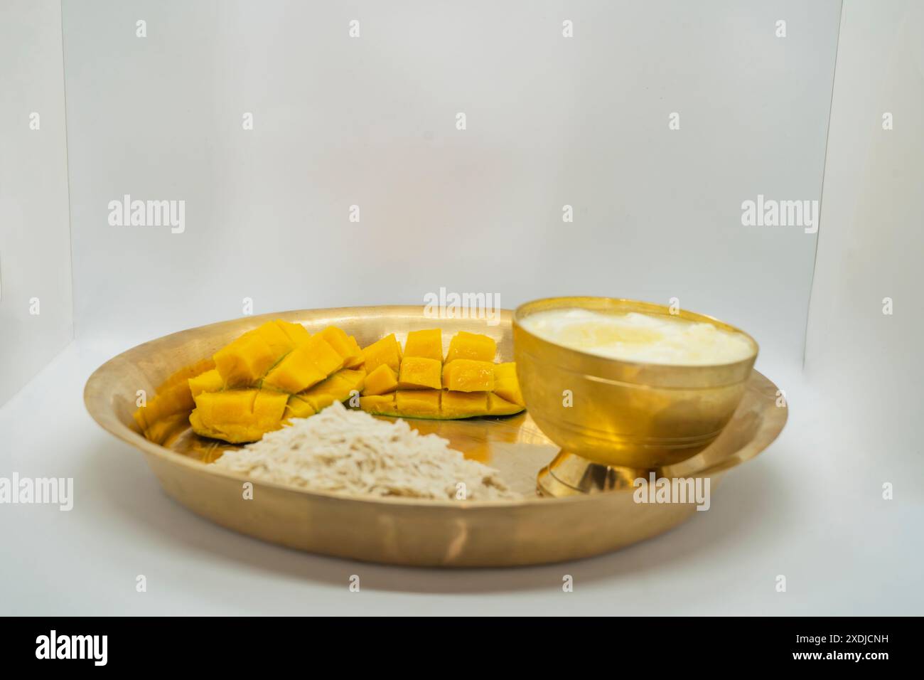 A copper plate and bowl of Dahi Chiura aka Yoghurt and Rice Flakes for ...