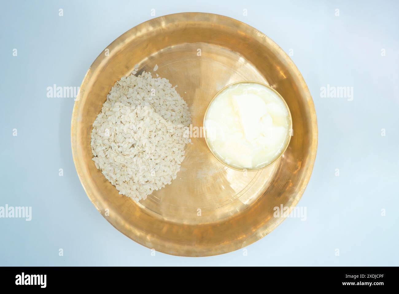 A copper plate and bowl of Dahi Chiura aka Yoghurt and Rice Flakes for ...