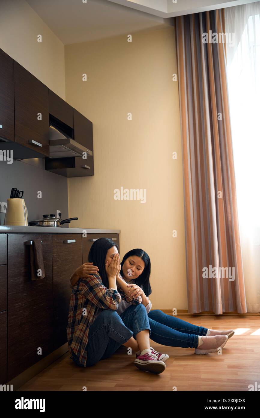 Crying daughter being consoled by compassionate parent Stock Photo - Alamy