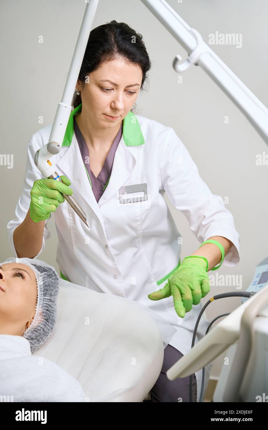 Cosmetologist using special device hi-res stock photography and images ...
