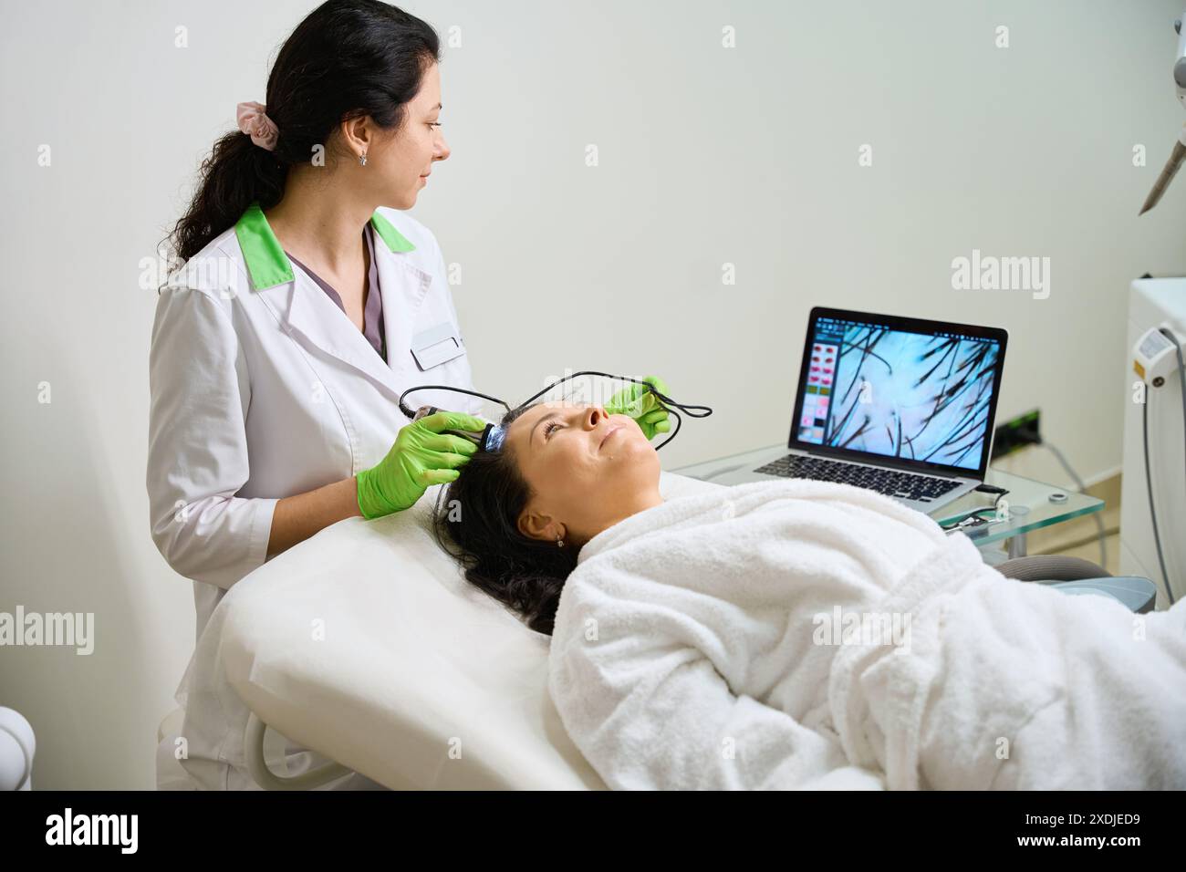 Diagnostic procedure using a trichoscope in a modern clinic Stock Photo ...