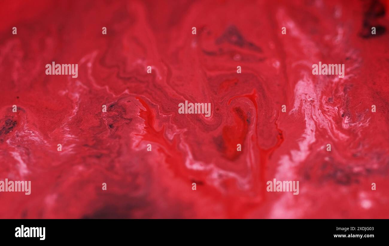 Paint flow. Acrylic liquid spill. Defocused red white black color ...