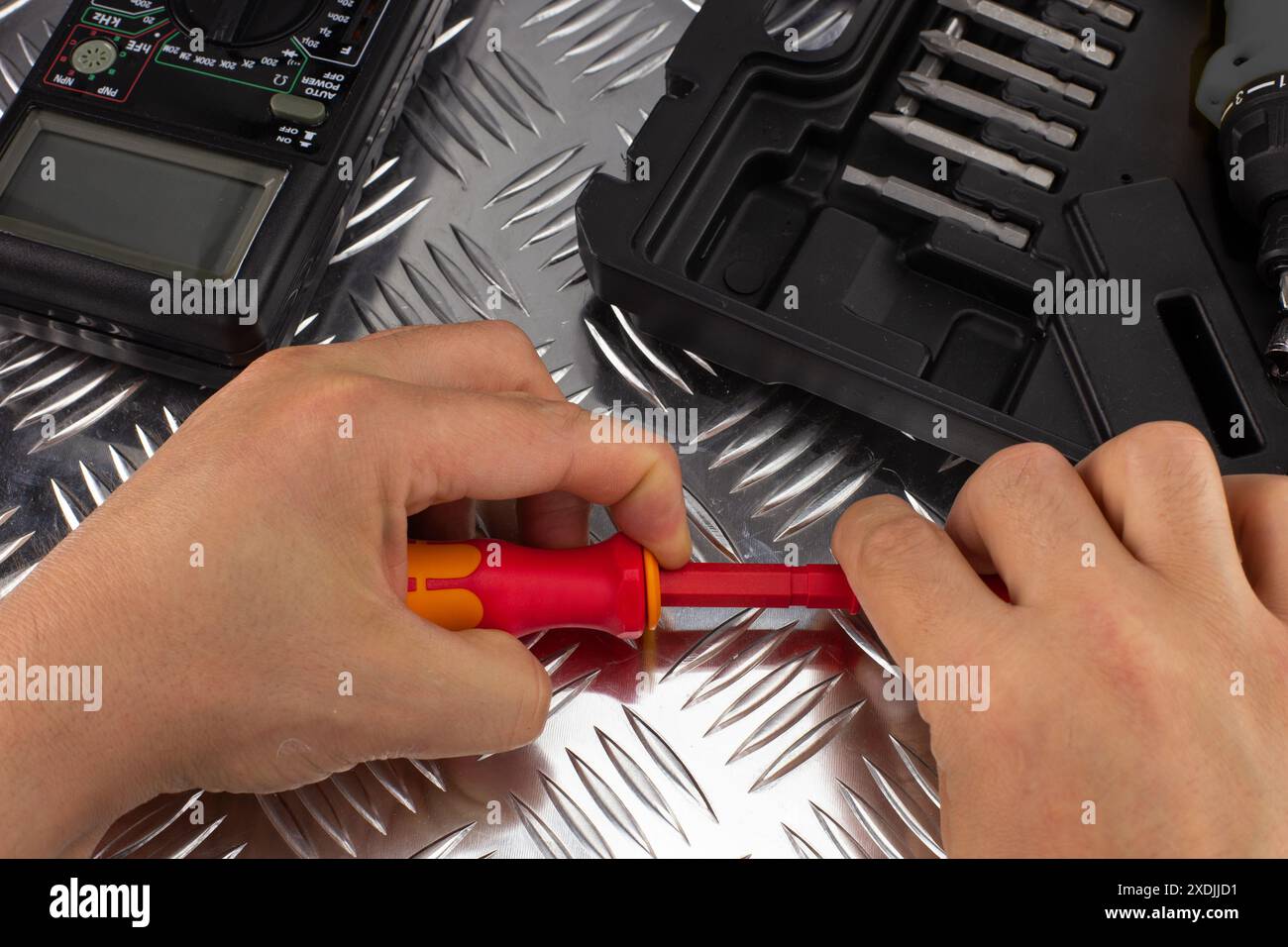 Hands Using Screwdriver with Tools Top View Stock Photo - Alamy