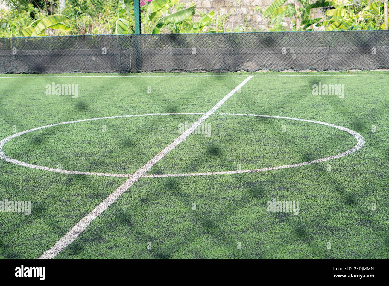 An empty outdoor soccer field with artificial turf, viewed through a ...