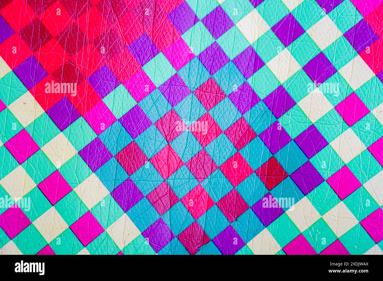 Colorful geometric pattern with diamond shapes in vibrant hues of pink ...