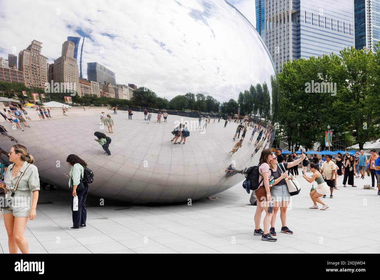 Visitors take photos of the "Cloud Gate" sculpture, also known as the ...