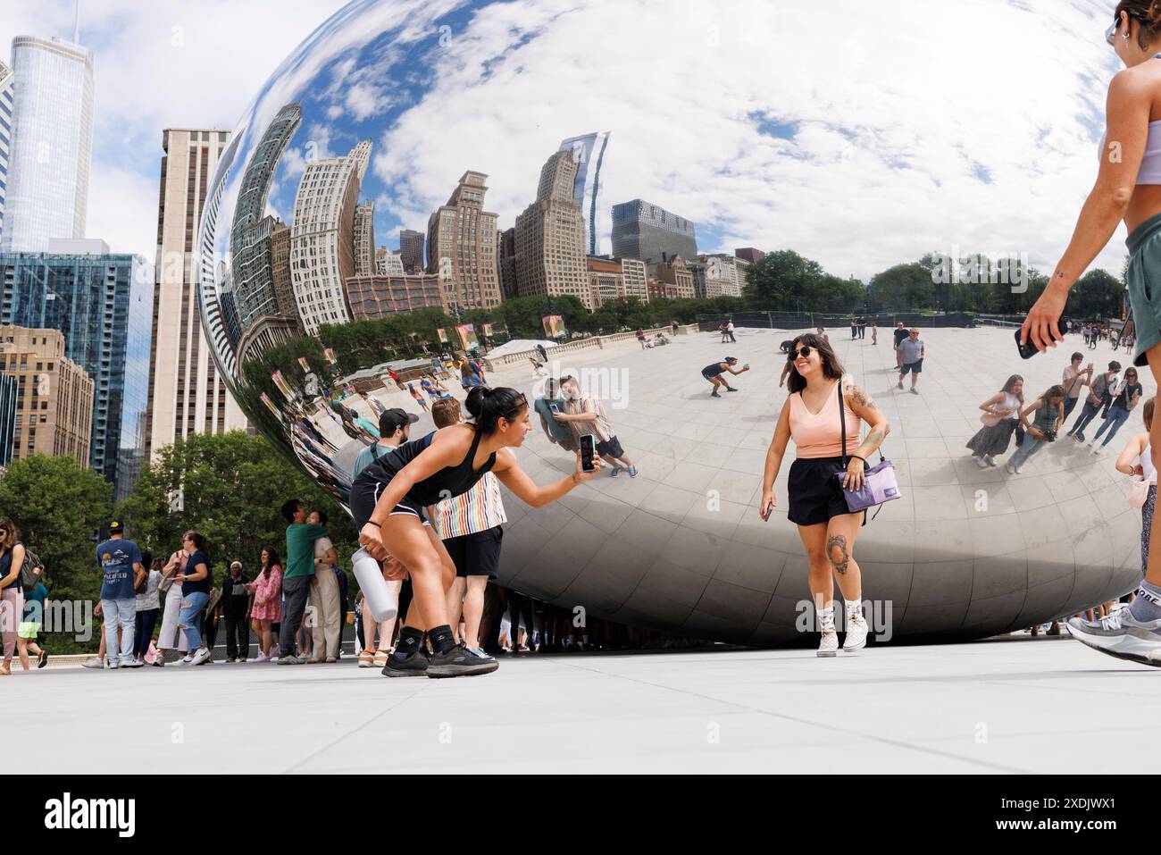 Visitors take photos of the "Cloud Gate" sculpture, also known as the ...