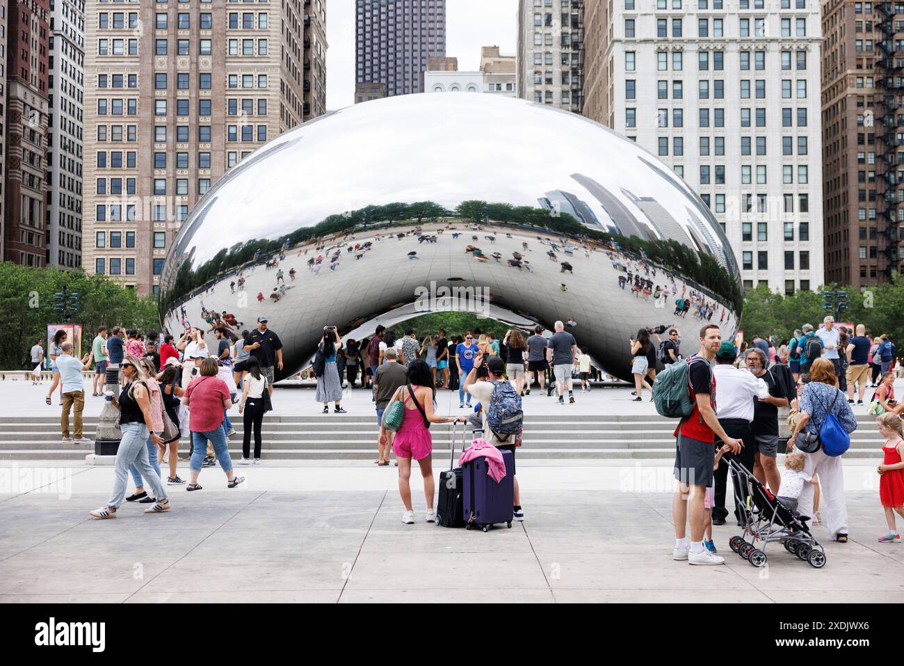 Visitors take photos of the "Cloud Gate" sculpture, also known as the ...
