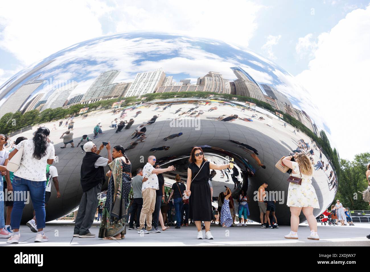 Visitors take photos of the "Cloud Gate" sculpture, also known as the ...