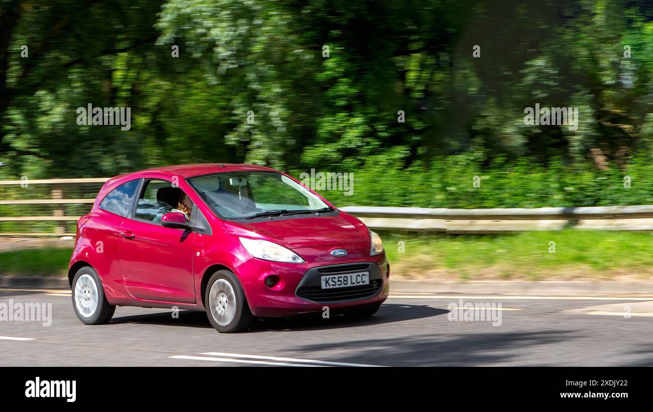 Milton Keynes,UK - June 22nd 2024: 2009 red Ford Ka car driving on a ...