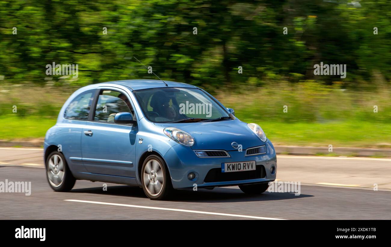 Milton Keynes,UK - June 21st 2024: 2010 blue Nissan Micra car driving ...