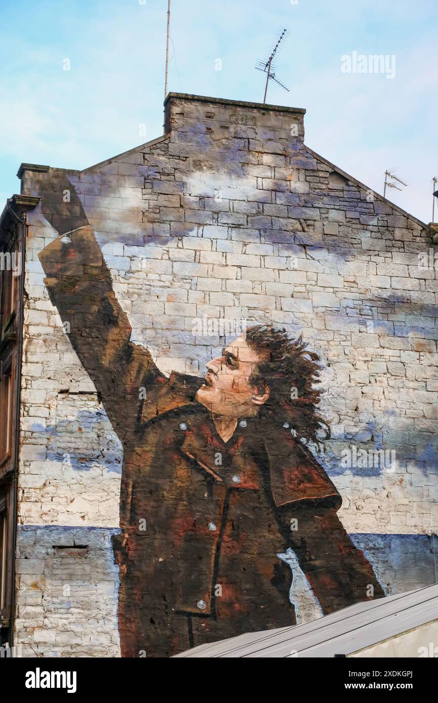 Mural painting depicting Billy Connolly reaching out to the sky, part ...