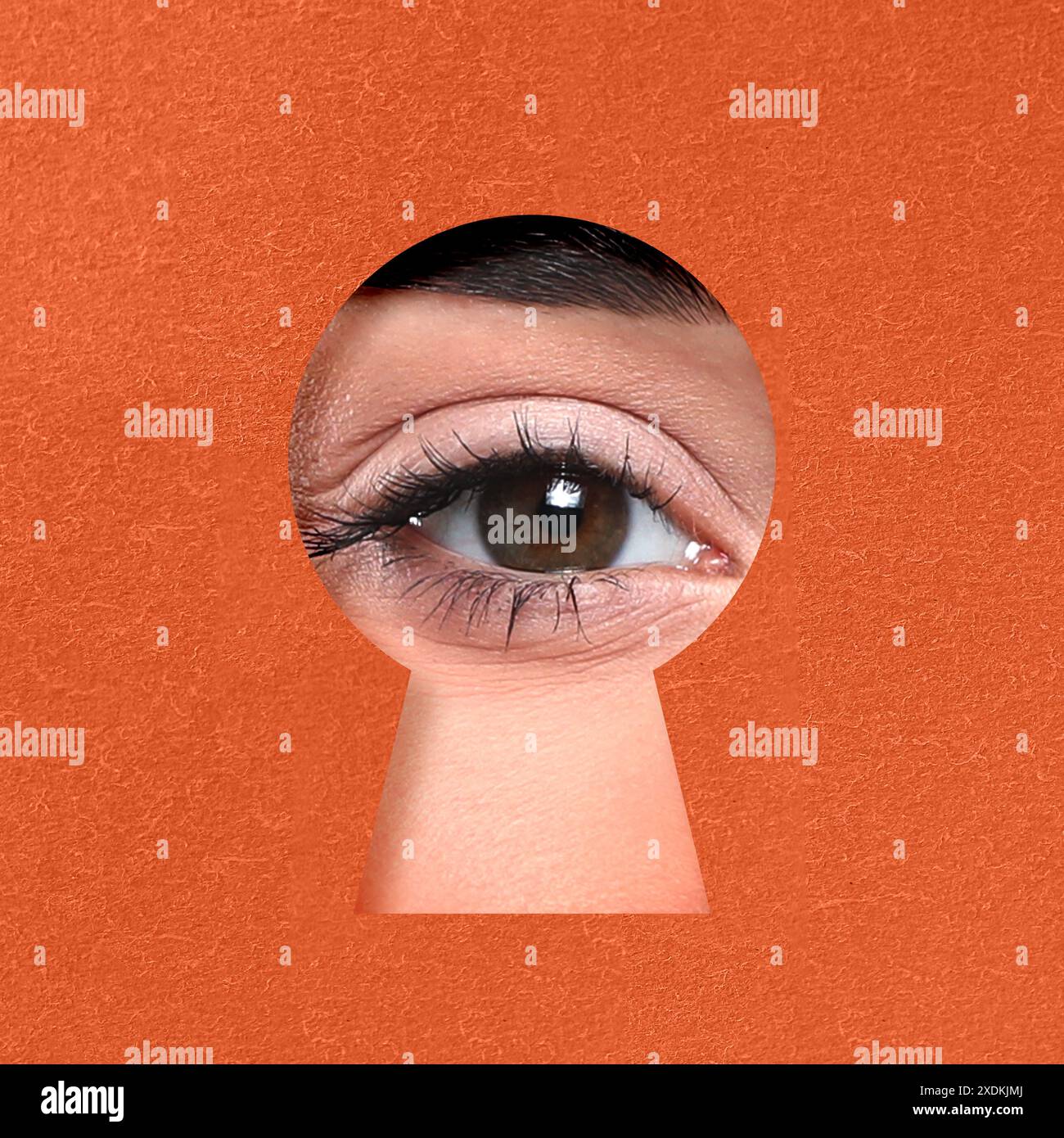 Woman looking through keyhole in dark orange surface Stock Photo - Alamy