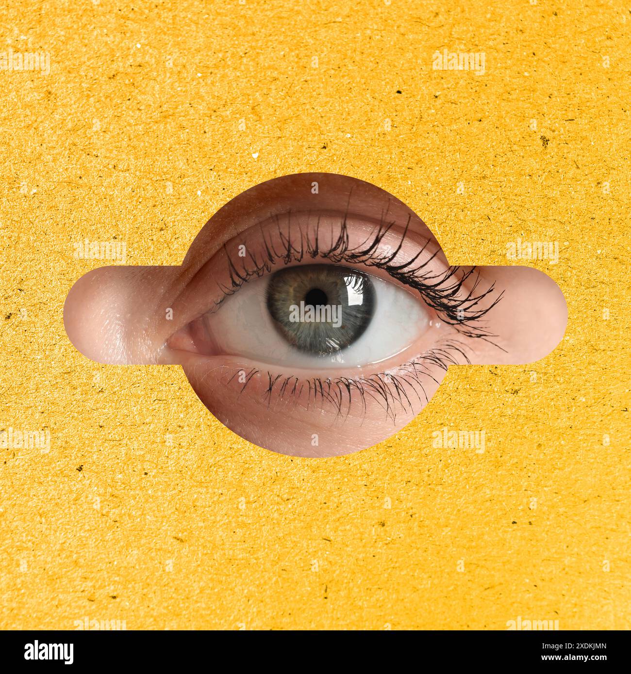 Woman looking through keyhole in yellow surface Stock Photo - Alamy