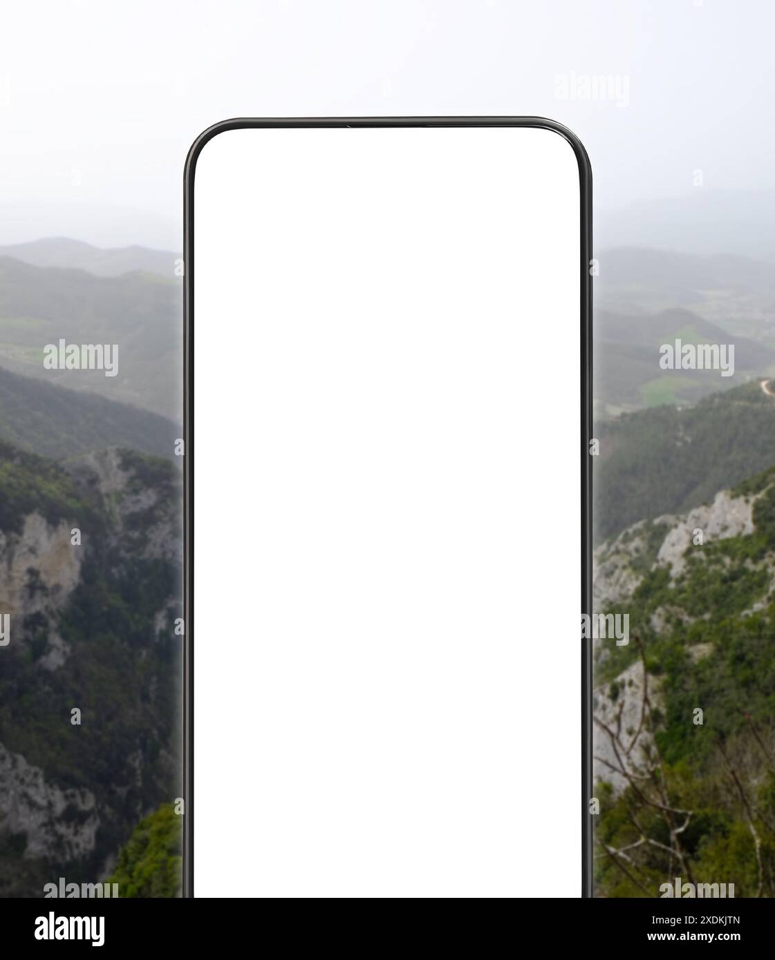 Mobile phone with empty screen against mountain landscape. Space for ...