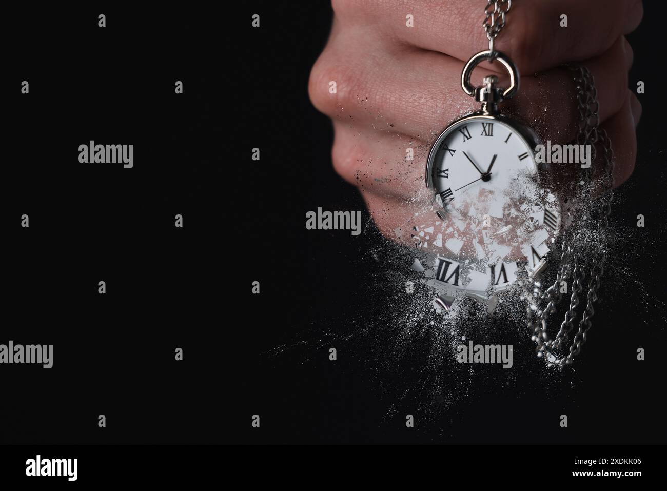 Businessman holding dissolving chronometer on black background, closeup ...