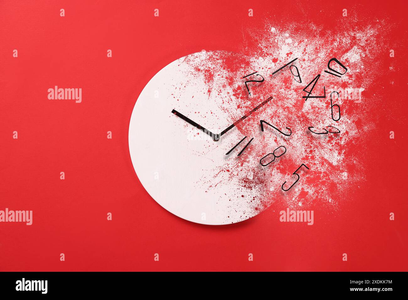 Analog clock dissolving on red background. Time is running out Stock ...