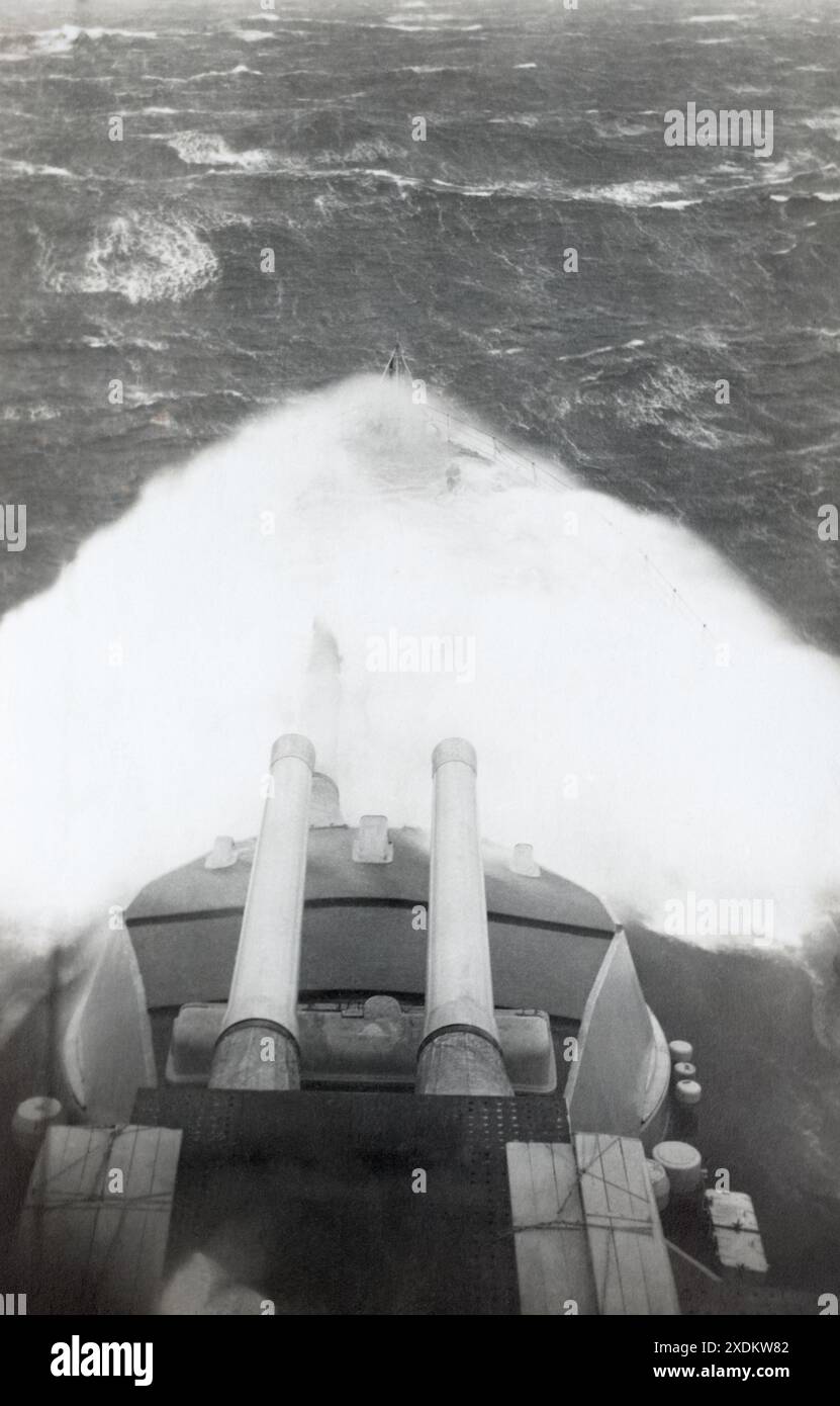 The bow of HMS Royal Oak breaking through a rough sea c. 1930's Stock ...