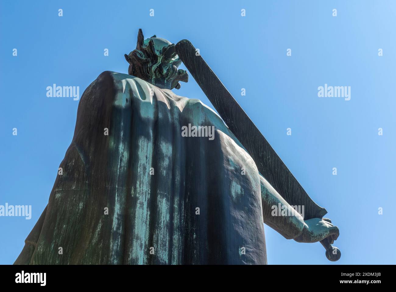 Odense, King Knud statue, crown, sword, tower of the cathedral church ...