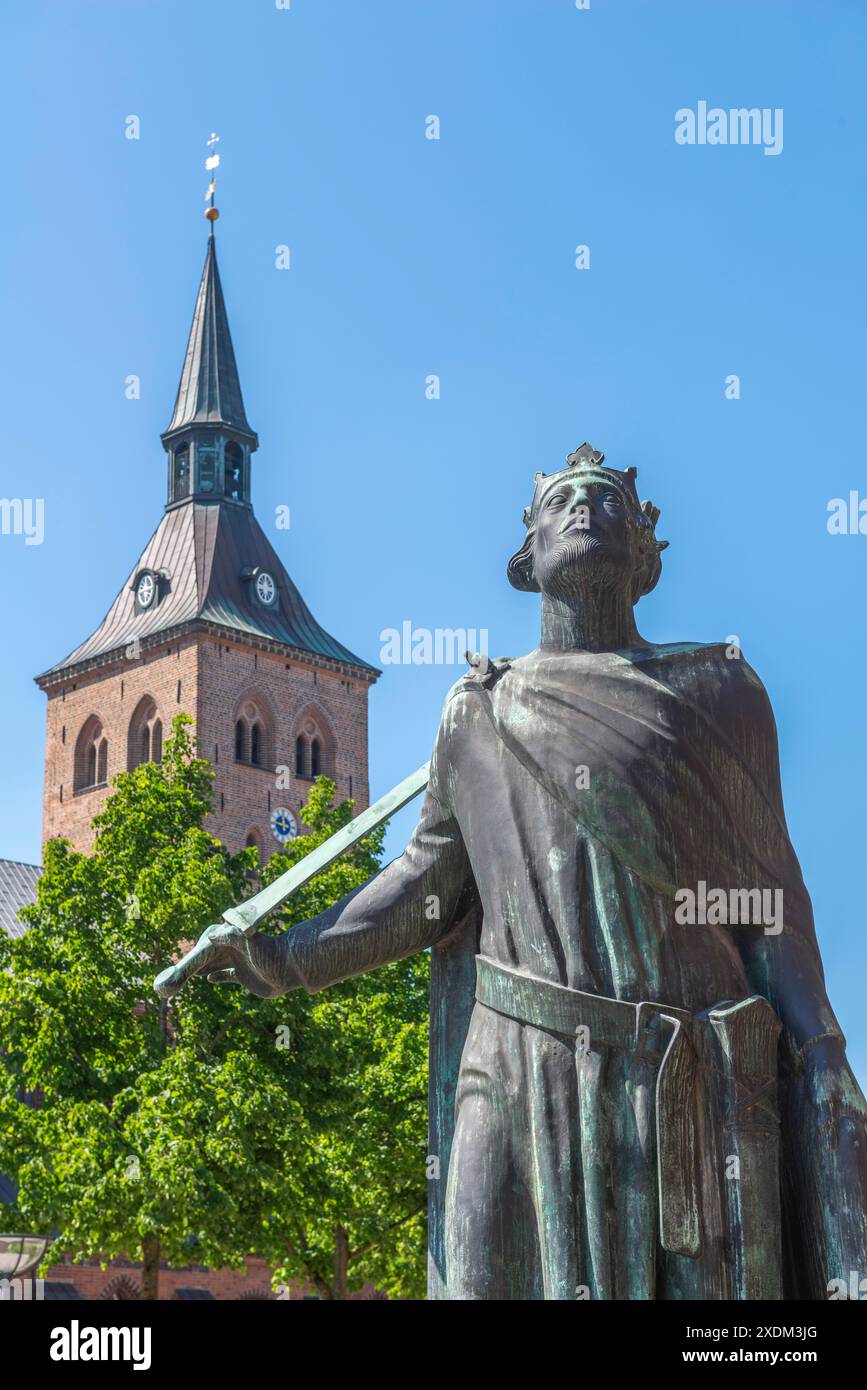 Odense, King Knud statue, crown, sword, tower of the cathedral church ...