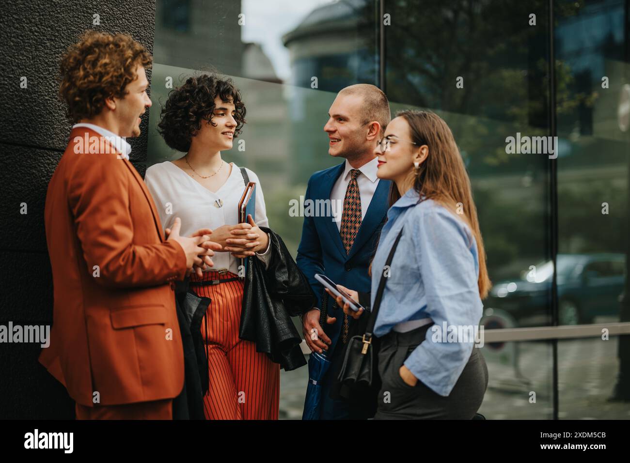 Businesspeople having an outdoor meeting with a discussion on a project ...
