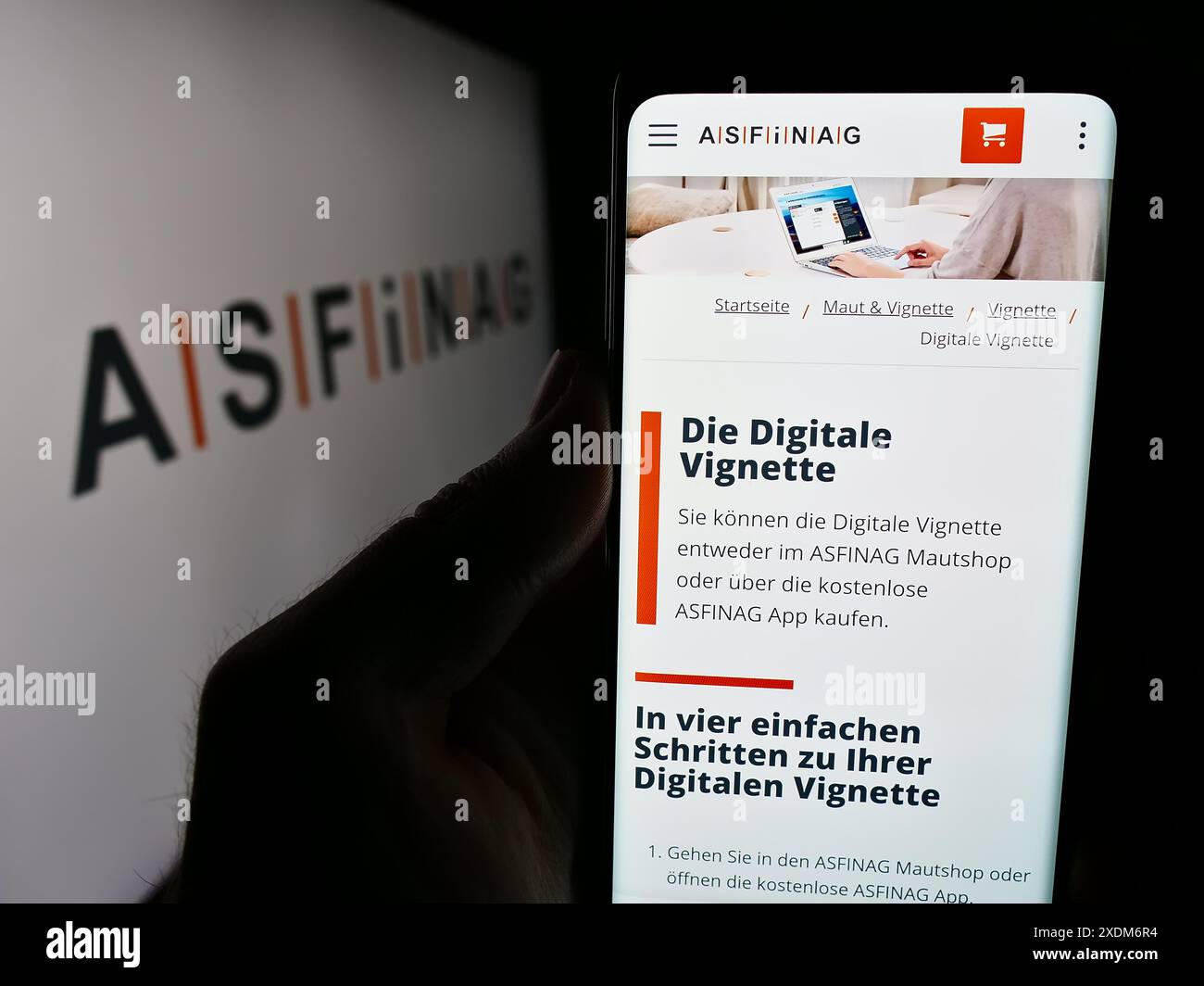 Person holding cellphone with webpage of Austrian motorway ...