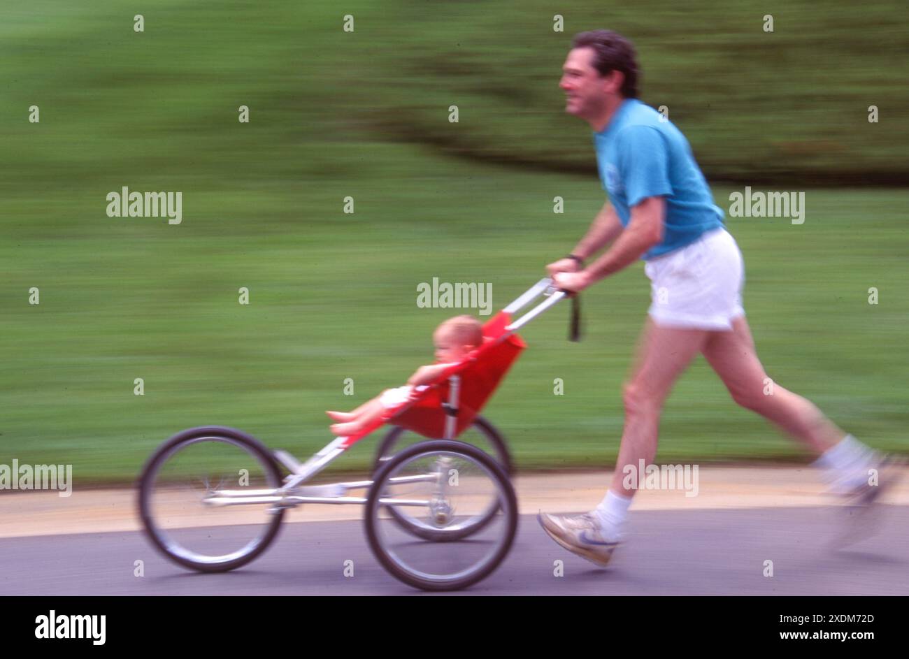 Father Jogging with his baby daughter in stroller, USA 1992 Stock Photo ...