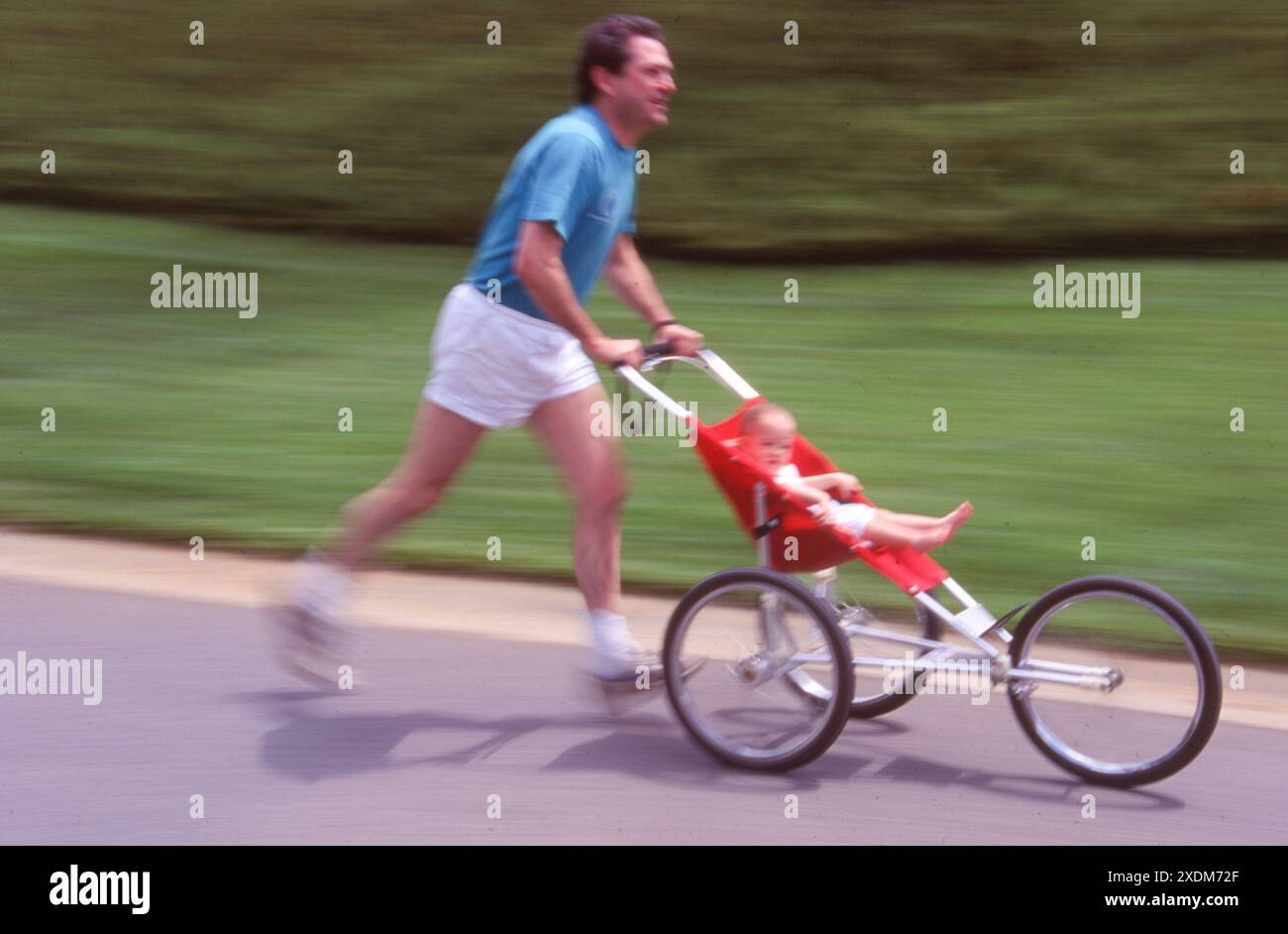 Father Jogging with his baby daughter in stroller, USA 1992 Stock Photo ...