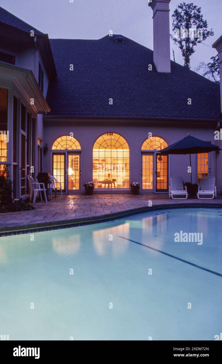 Residential home at night with lit windows, USA 1998 Stock Photo - Alamy