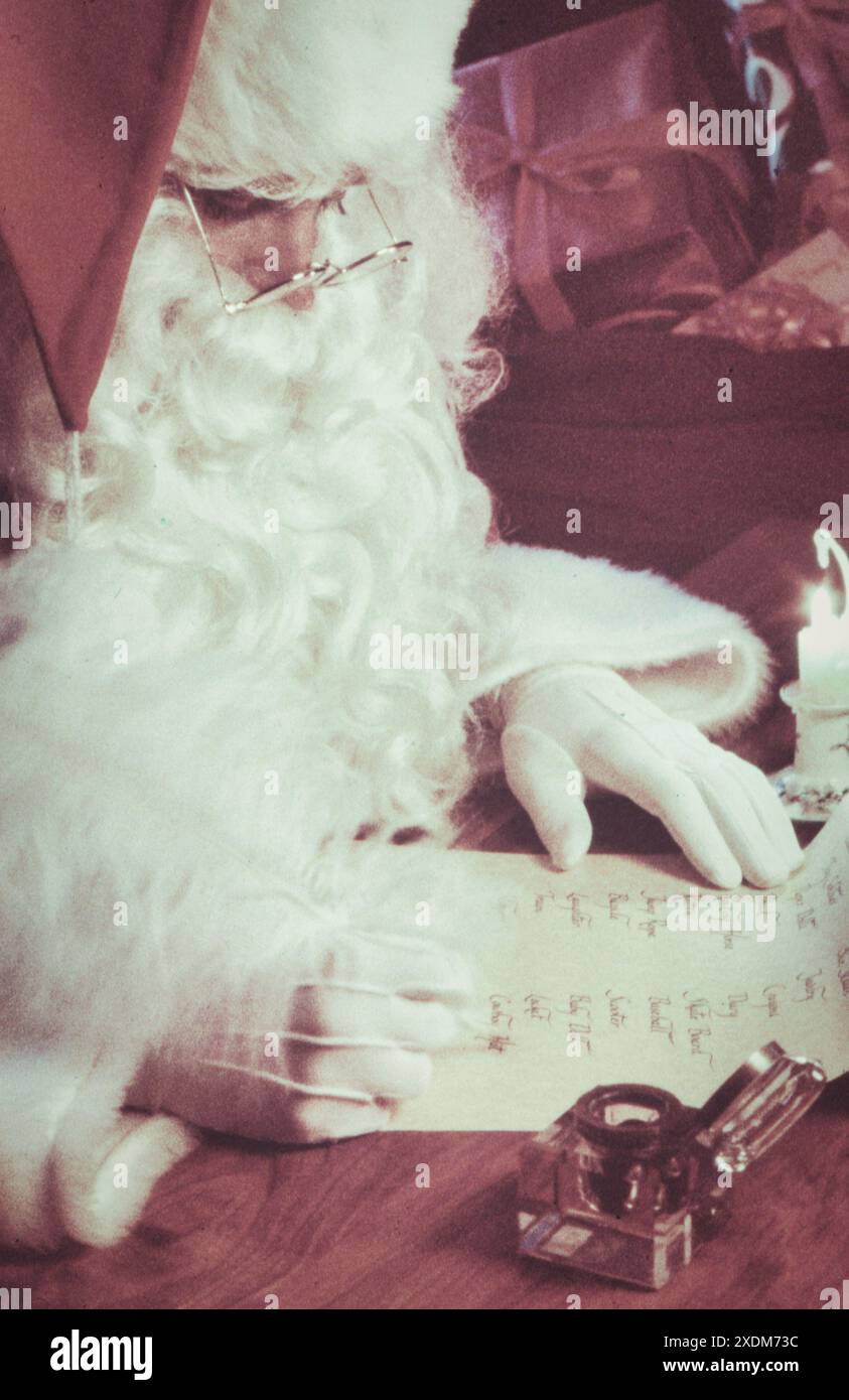 Santa Claus working on Naughty or Nice Gift List, USA Stock Photo - Alamy